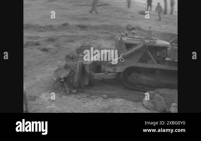 1943 - American soldiers use a bulldozer to widen a beach on Kiska ...