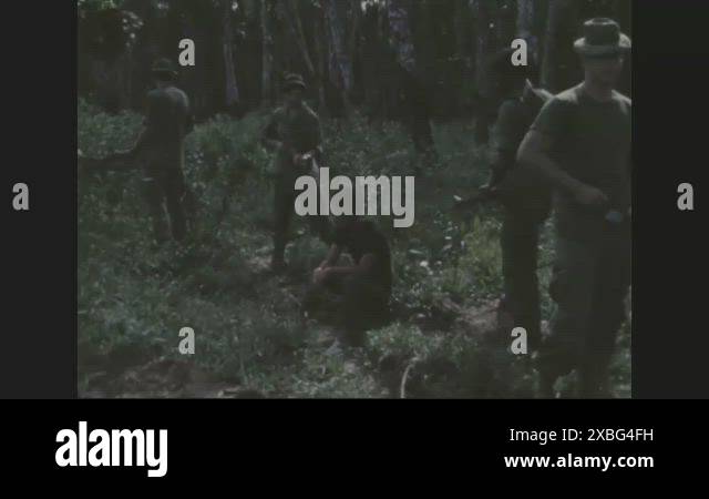 A Vietnamese prisoner of war is questioned by officers in a jungle ...