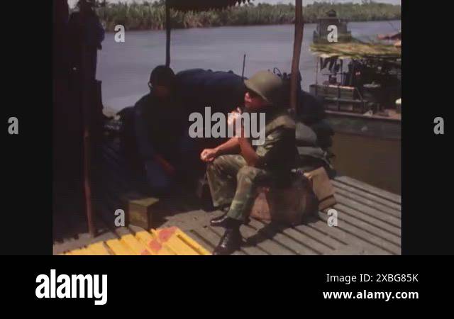 South Vietnamese soldiers and United States Marines look at a map and ...
