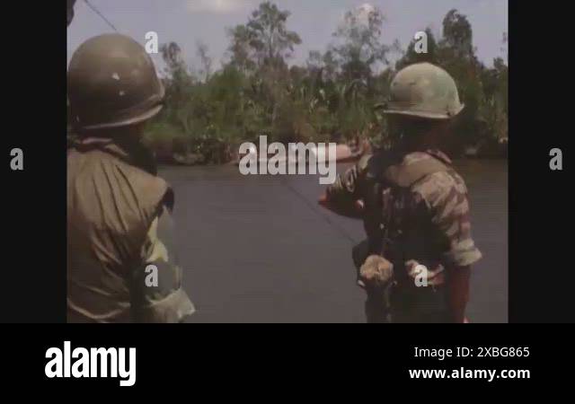 South Vietnamese soldiers and United States Marines shoot napalm from a ...