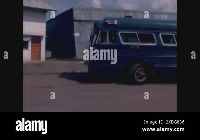 An ambulance bus approaches a military transport aircraft on an ...