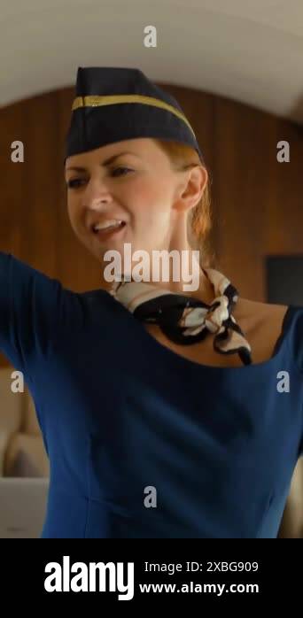 Stewardess joyfully dancing inside of private jet cabin, during flight ...