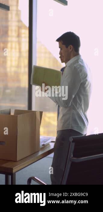 Two businessman caucasian and african american in office unpack his box ...