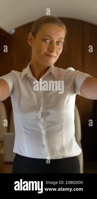 Happy successful female dancing In private jet cabin. Exclusive falcon ...
