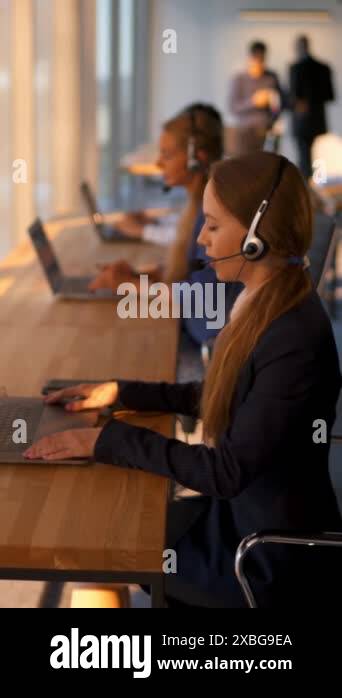 Call center consulting clients in modern glass business center. Back ...