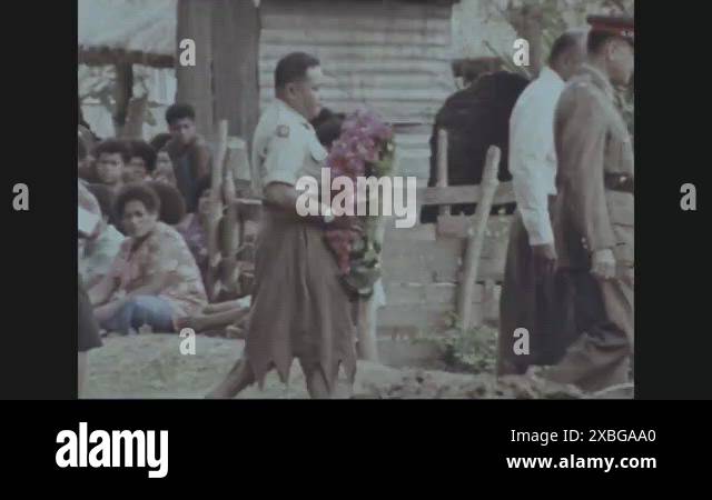 A funeral is shown as well as various headstones in a cemetery in the ...