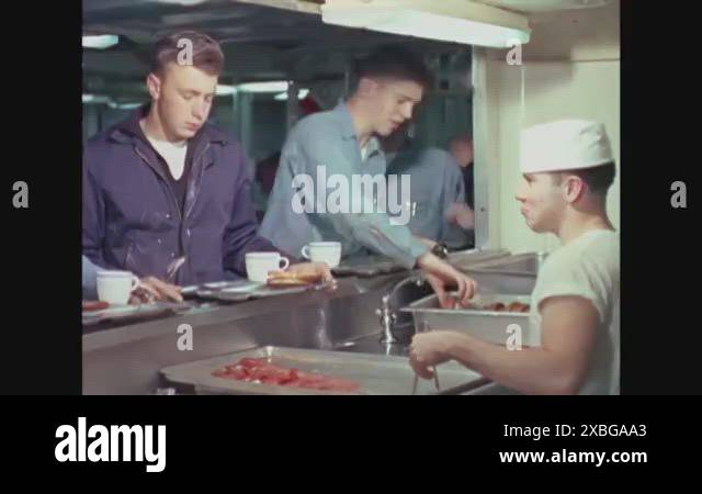 Sailors are served and they are shown eating in the galley aboard the ...