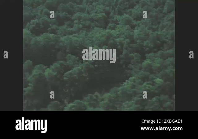 1982 - A Marine helicopter lands in a clearing above a smoke signal, in ...