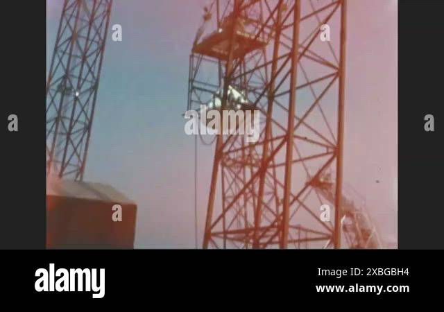 1965 - Shown in slow motion from a side view, an Apollo command module ...