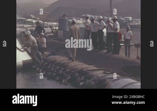 1965 - Engineers take a look inside an Apollo command module after a ...