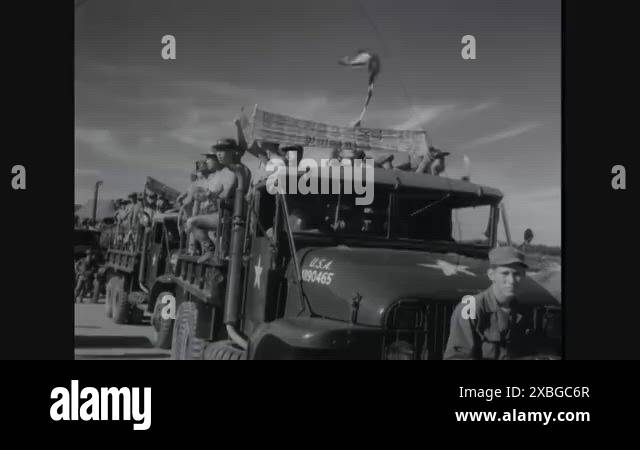 1953 - A convoy of US Army trucks carries North Korean POWs, who are ...