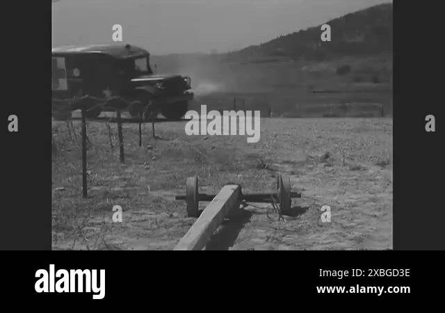 1953 - A man on a stretcher is brought from a Red Cross truck to a tent ...