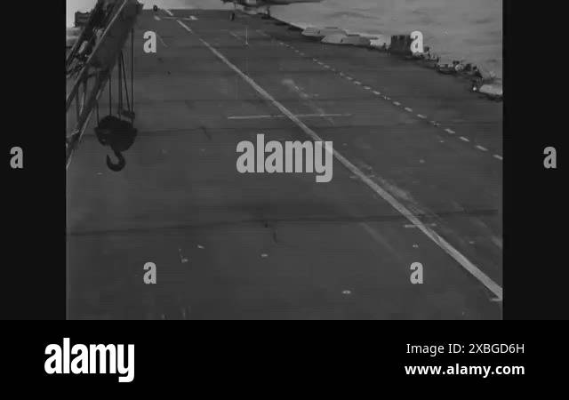 1944 - A Navy plane lands on the deck of an aircraft carrier and ...
