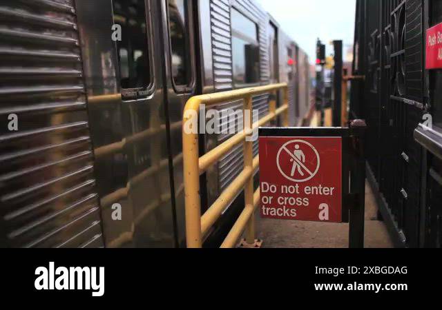 A train pulls out of a station in New York City next to a sign warning ...