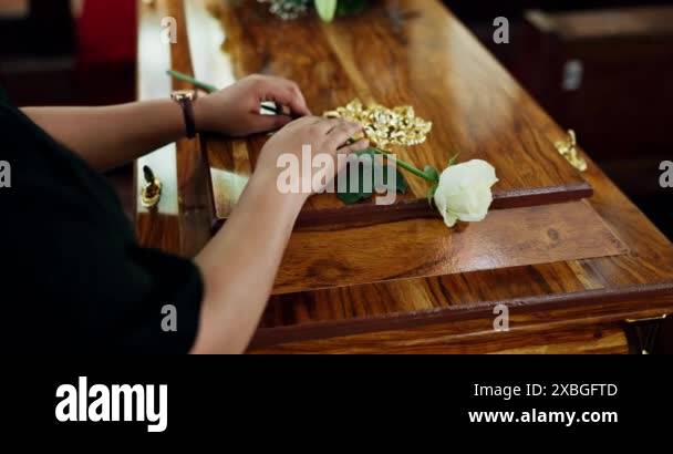 Coffin, flower and hands of widow at funeral for goodbye with grief ...