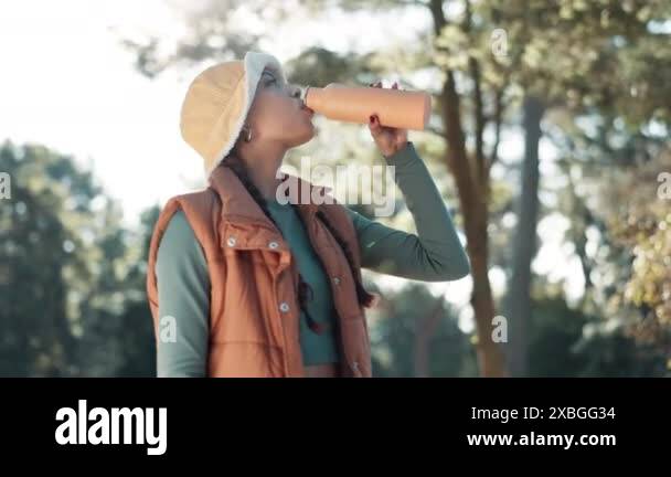 Hiking, woman and drinking water in forest for hydration, wellness and ...