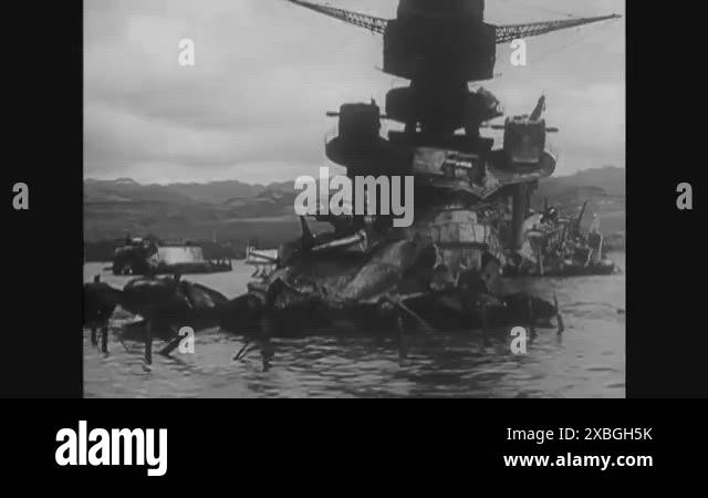 1941 - US Navy use rowboats to approach the sinking wreckage of the USS ...