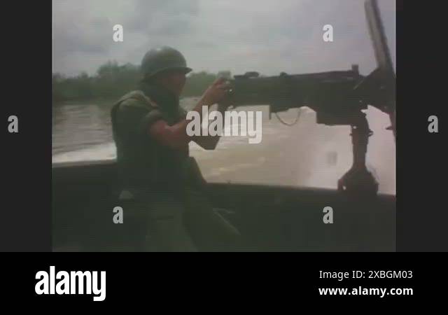 Soldiers fire a 50 cal. machine gun from their patrol boat during the ...