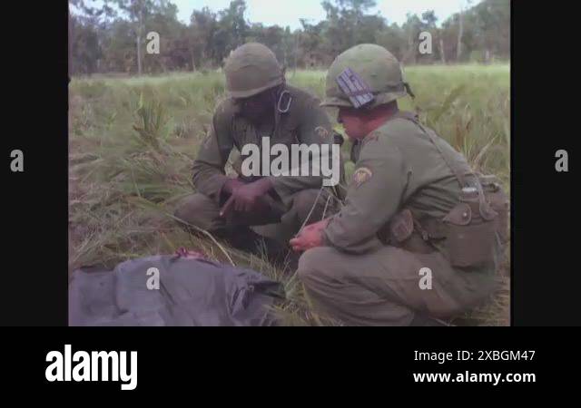 1965 - Badly wounded soldiers are taken on stretchers to a UN-1D helicopter, during the Vietnam ...
