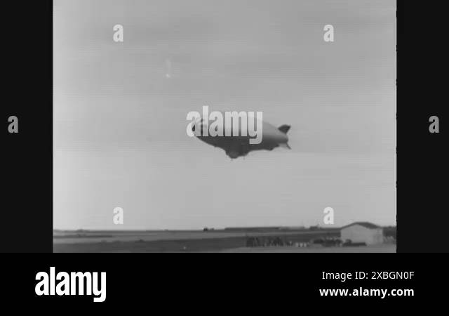 1958 - The ground crew at a US Navy station helps moor a blimp ...