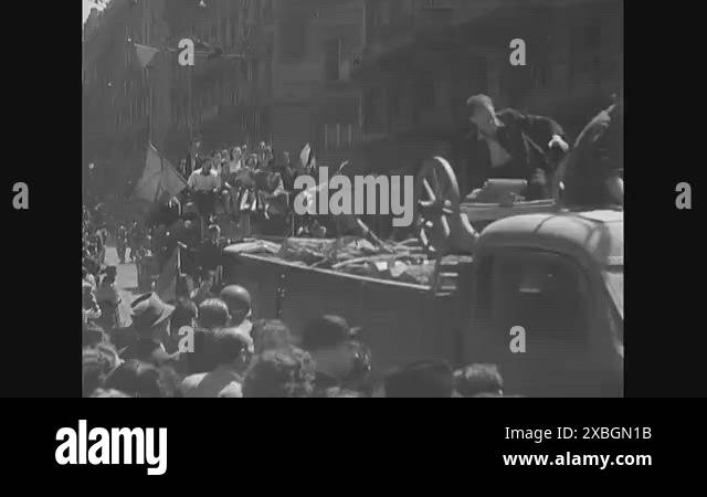 1944 - Civilians of all ages line the streets to cheer as US Army jeeps ...