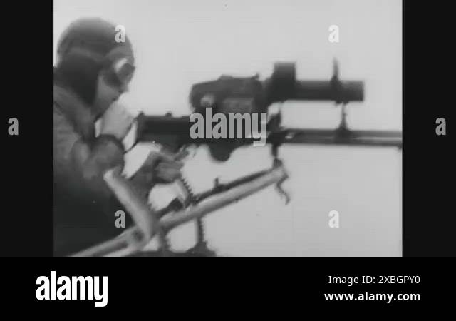 A pilot mans the mounted machine gun on the back of his plane, 1939 ...