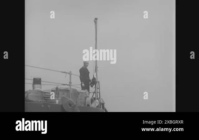 1951 - Many flags and the commissioning pennant are raised on the USS ...