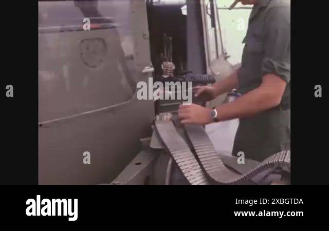1967 - US Navy helicopter pilots load ammunition and rockets into their ...