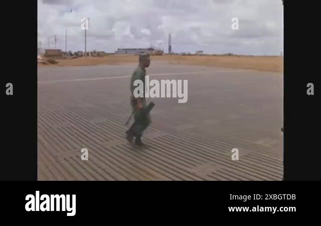 1967 - US Navy mechanics work on mini-guns and rocket pods for ...