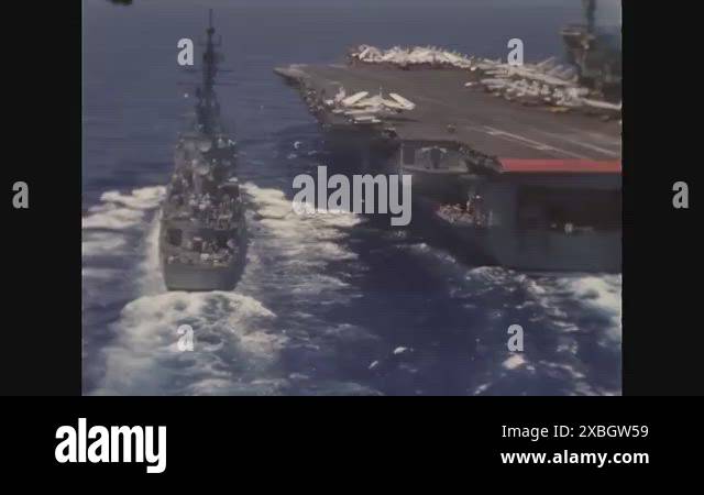 Warships are shown alongside the USS America as it is refueled in the ...