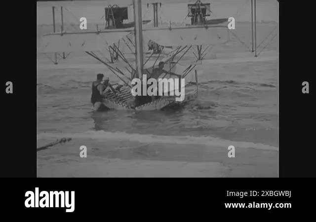 1920s - A US Navy seaplane is towed onto the beach. Navy pilots use ...