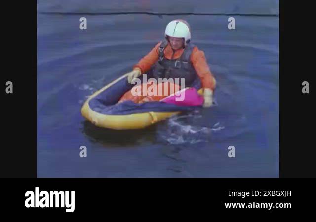 Pilot seated in one man raft gets out and into water as raft flips over ...