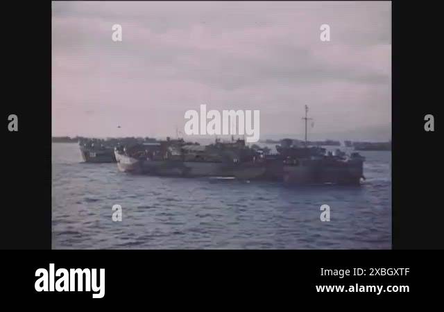 LST convoy enroute to Iwo JIma, a service member on conning tower of ...
