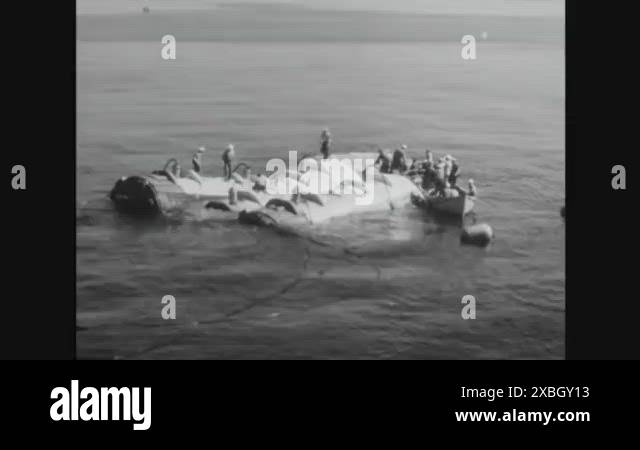 1939 - US Navy sailors get aboard the pontoons of the USS Squalus ...