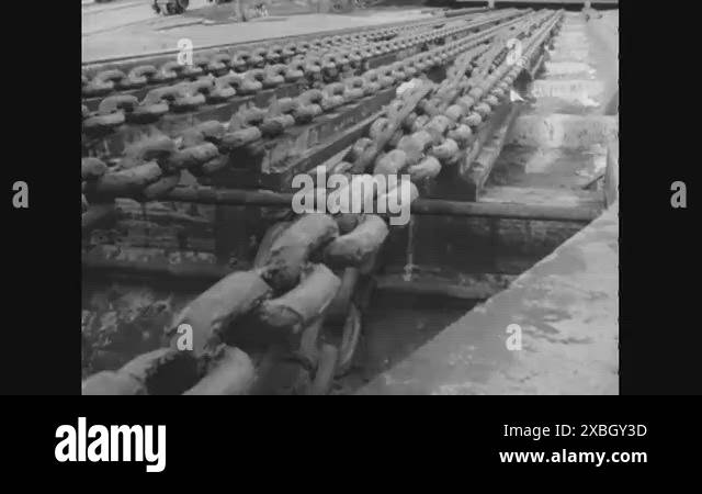 1941 - Anchor chains and cranes are used on a dry dock at Pearl Harbor ...