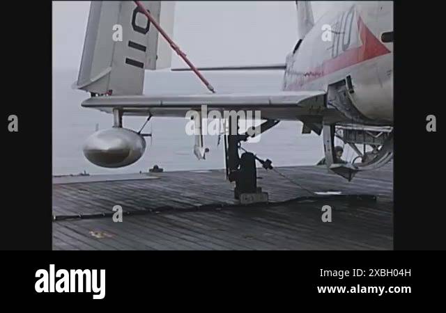 1956 - Ordnance men move a bomb sled loaded up with sidewinder missiles ...