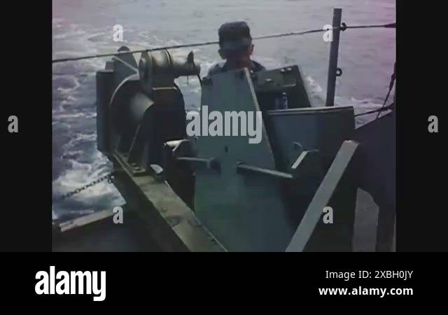 1970 - A US Navy sailor threads the kite tail through the fantail ...