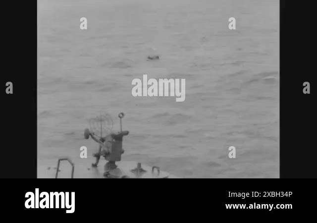 1945 - A rubber raft comes up alongside the USS Grayson, bringing ...