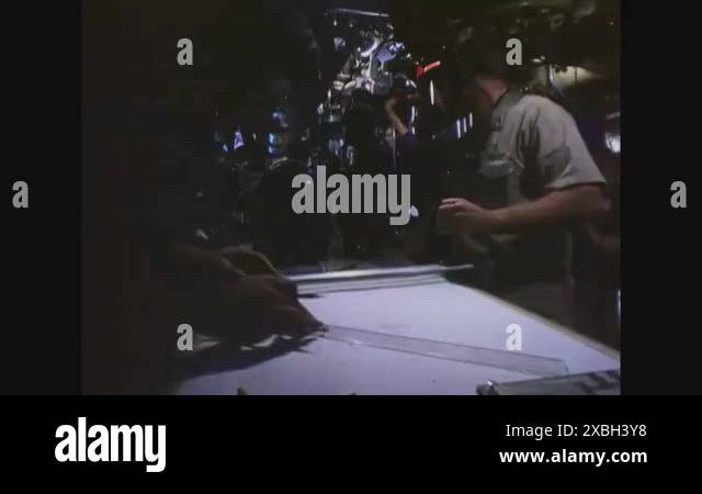 Officers plot a course on a chart aboard a United States Navy submarine ...