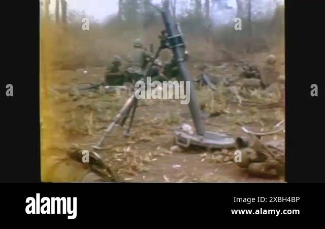 1967 - American soldiers crawl to foxholes while under enemy fire in ...