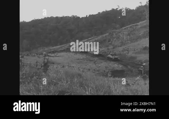 1944 - US Army tanks move along New Guinea. American soldiers come ...