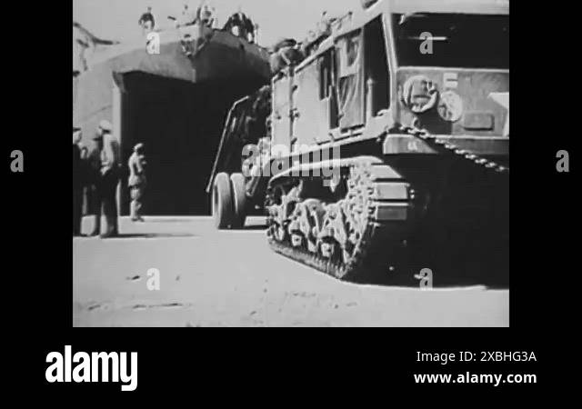 Tanks and artillery pieces and armored vehicles are brought aboard ...
