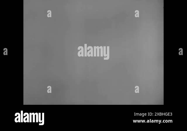 A tank is shown and troops hit the dirt and walls collapse and the roof ...