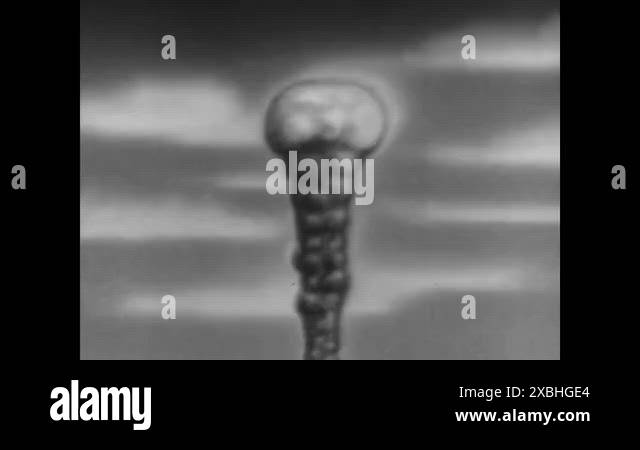 An animation shows the mushroom cloud of an atomic bomb blast and a ...