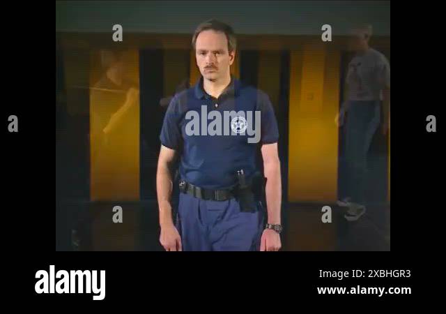 A U.S. Marshall grips an expandable baton and demonstrates the loaded ...