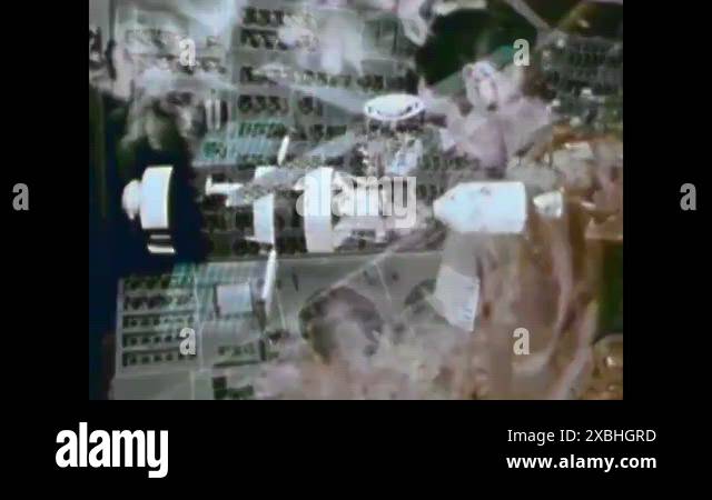 Skylab is shown in orbit and an astronaut rides a bicycle ergometer and ...