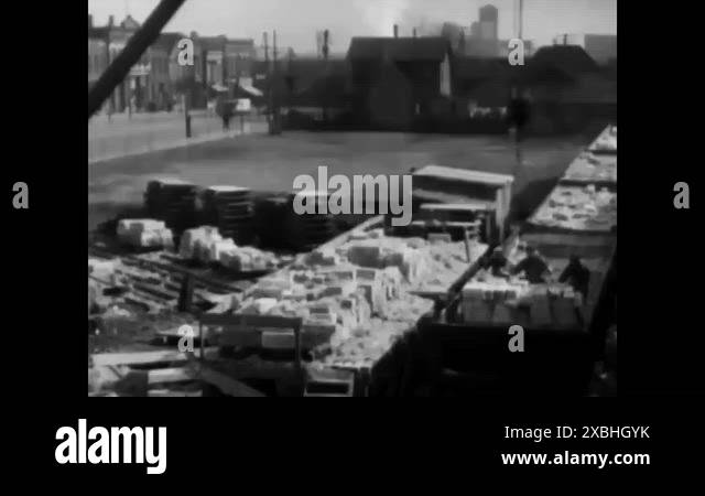 Granular limestone is loaded onto a truck and a wheelbarrow is used to ...