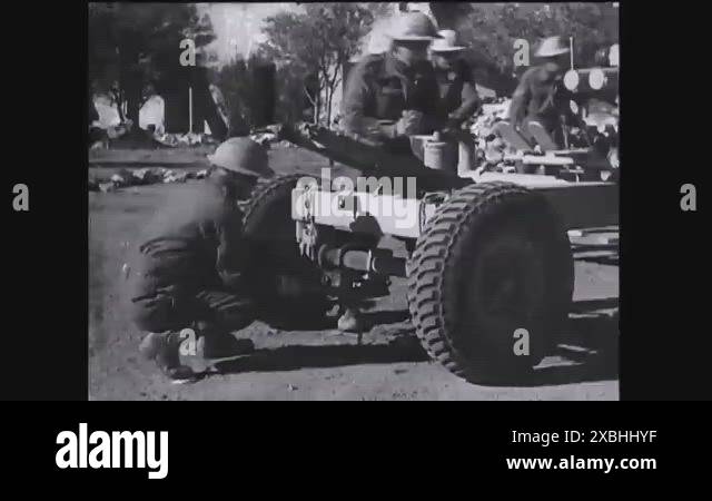 American soldiers in Europe setting up artillery and reloading the guns ...