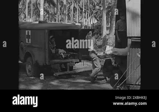 Sailors transfer litter cases to an ambulance and a doctor tags a ...