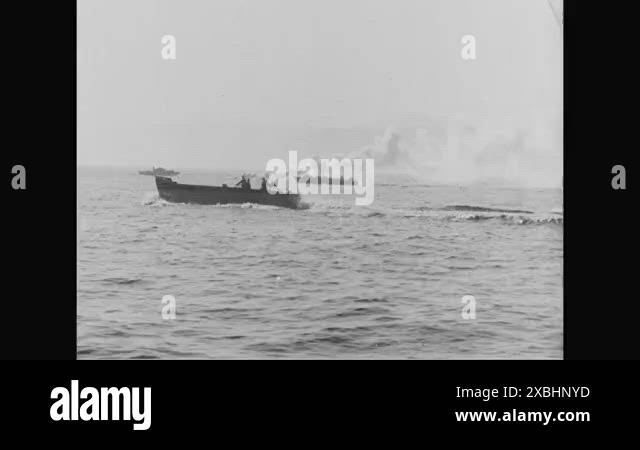 Troops emerge from landing barges on a beach and landmines are placed ...